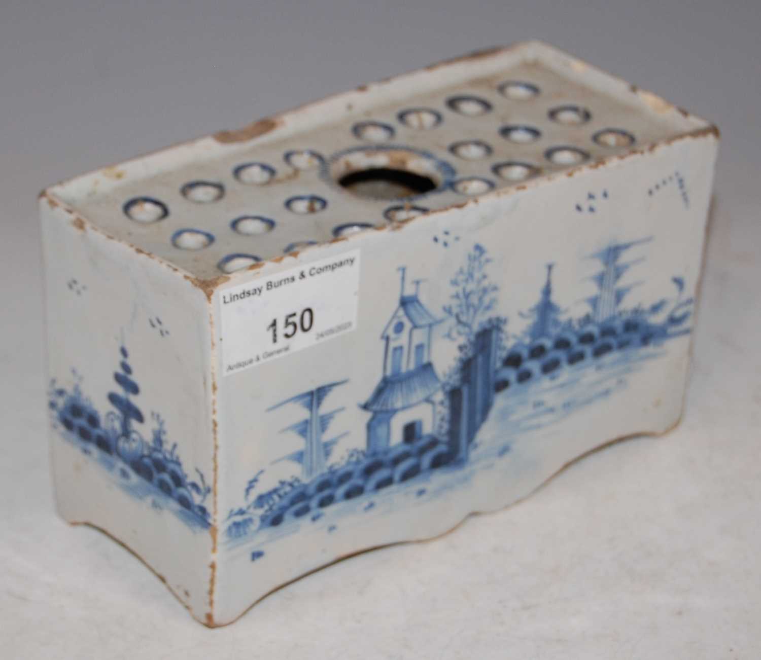 Lot 150 - An antique Delft pottery flower brick,
