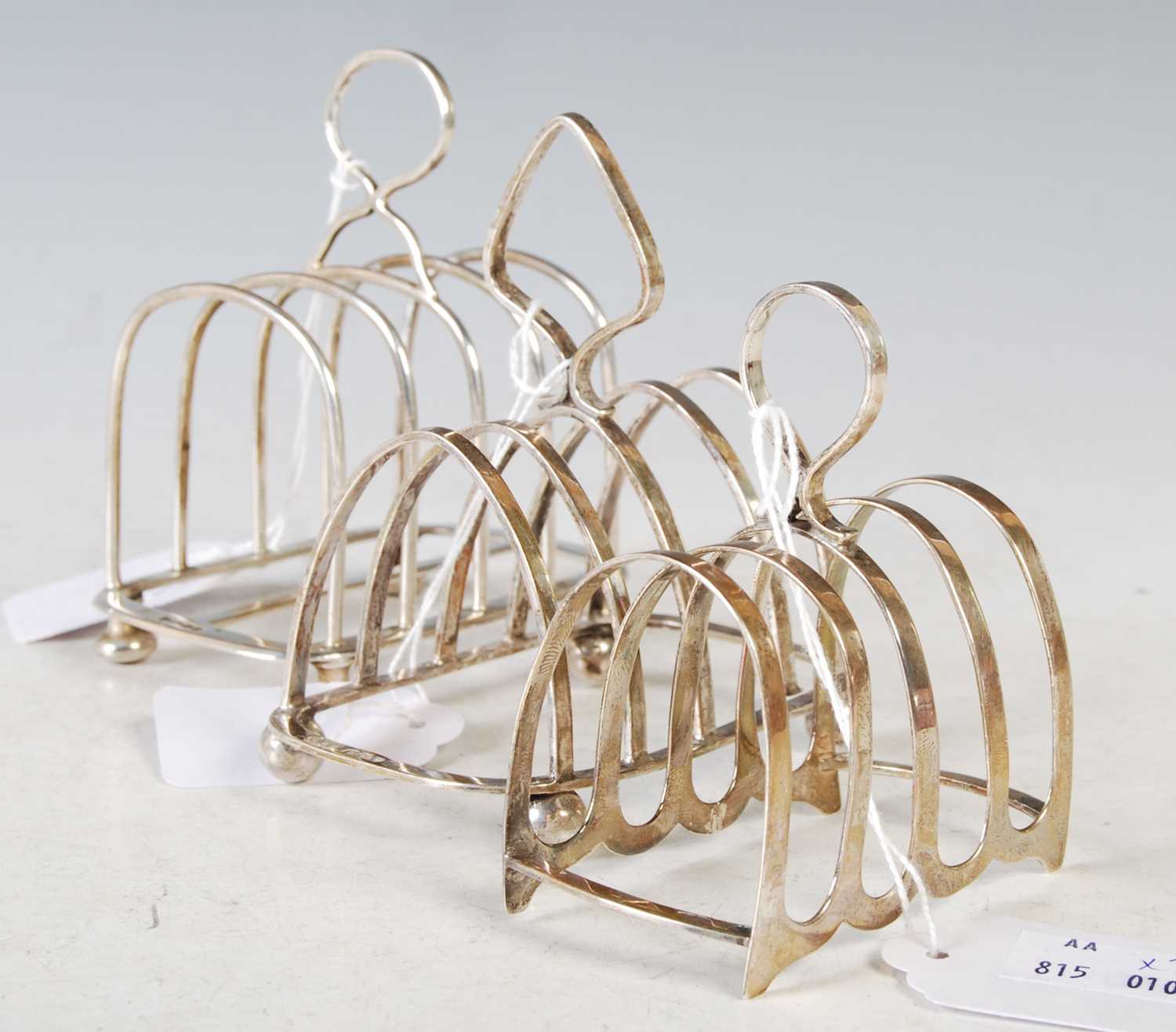 Lot 154 - Three assorted silver five-bar toast racks,