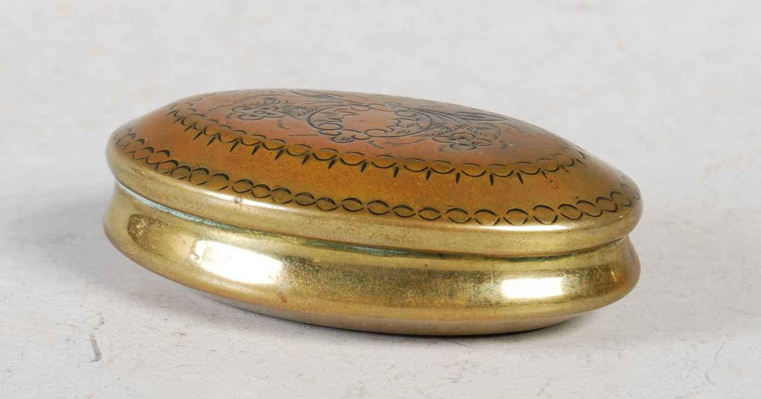 Lot 301 - A 19th century brass oval snuff box, the