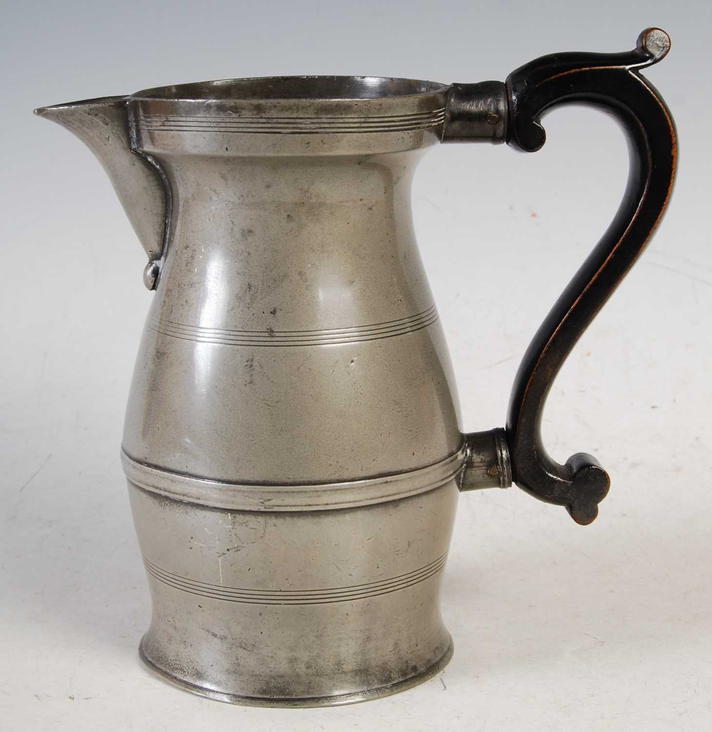 Lot 127 - A late 18th century pewter baluster jug with