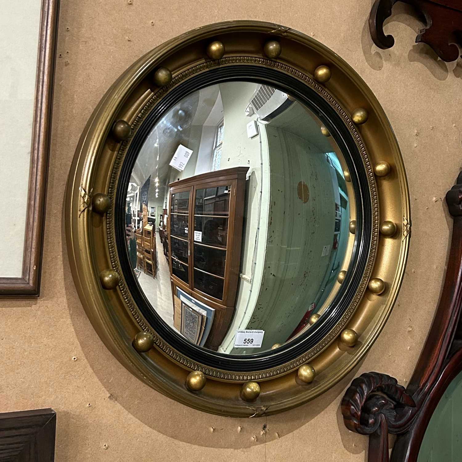 Lot 559 - A Regency style gilt circular convex mirror