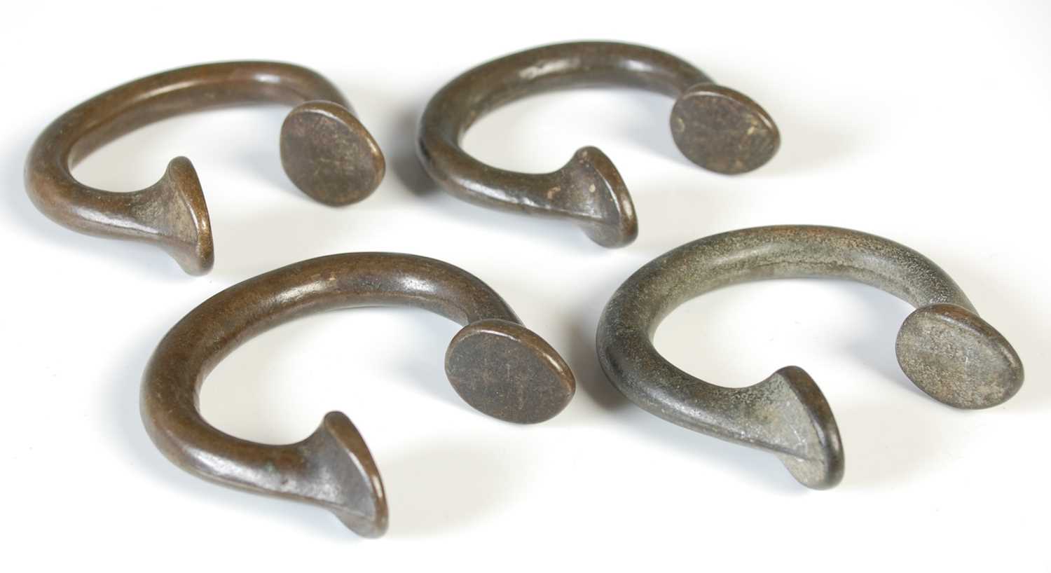 Lot 103 - Four West African manillas, gross weight 318.