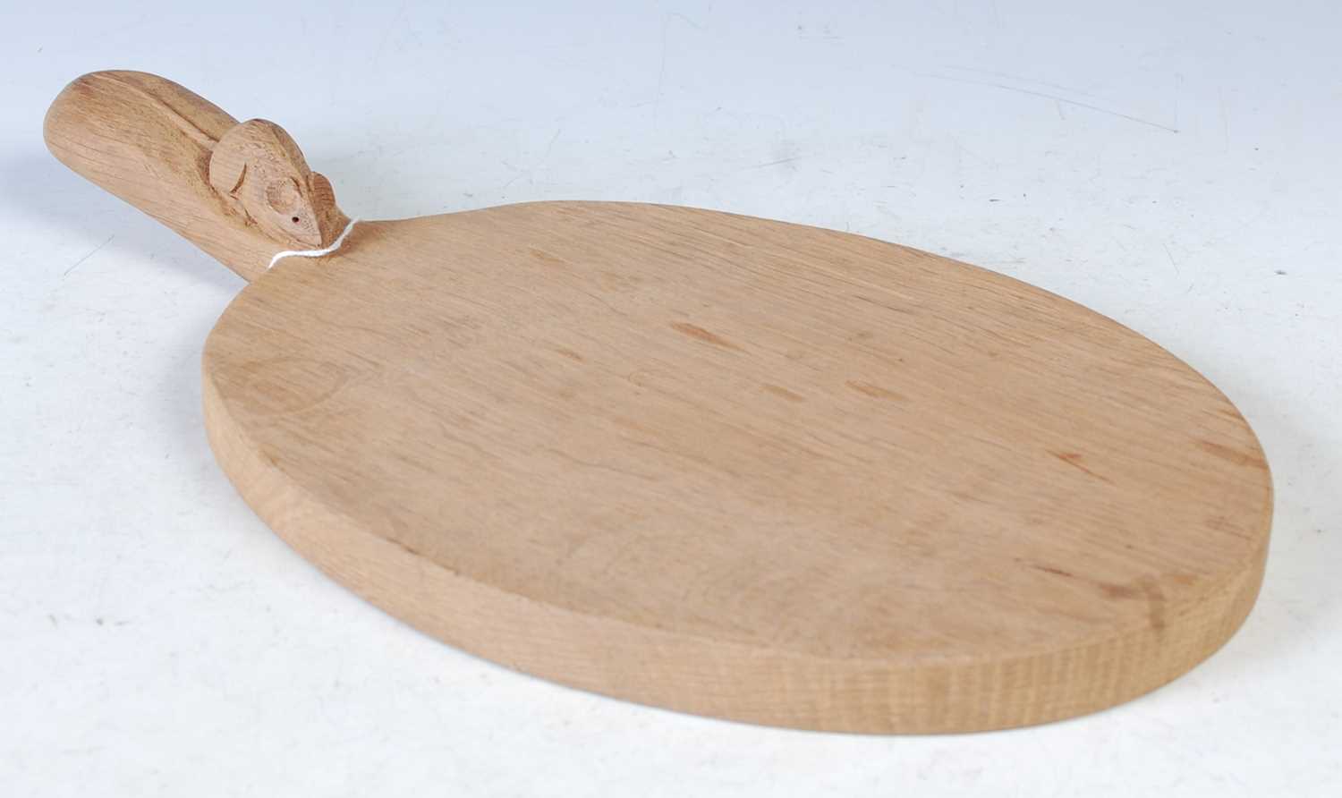 Lot 119 - A Mouseman oak cheese board, oval shaped,