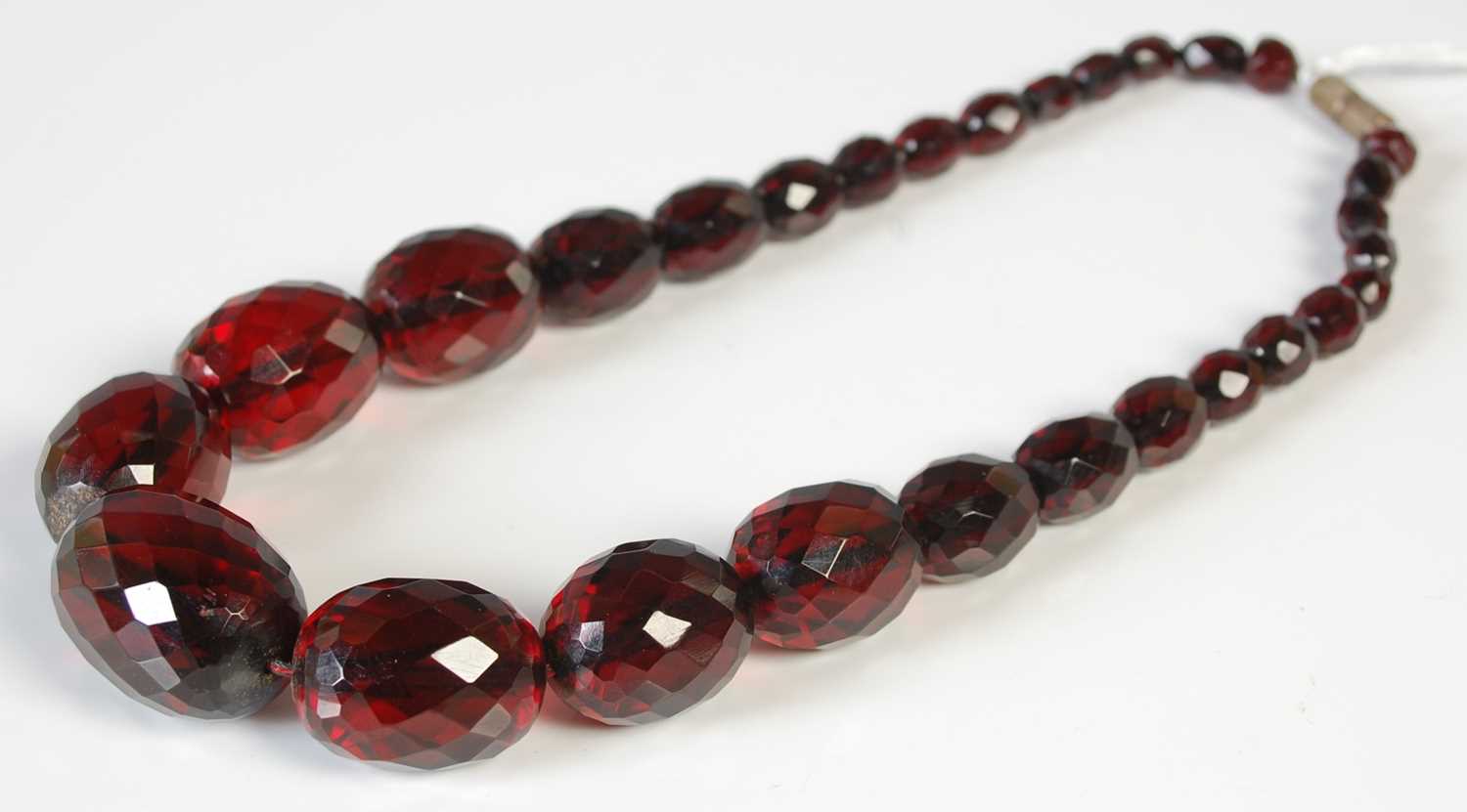 Lot 310 - A vintage red amber type faceted graduated