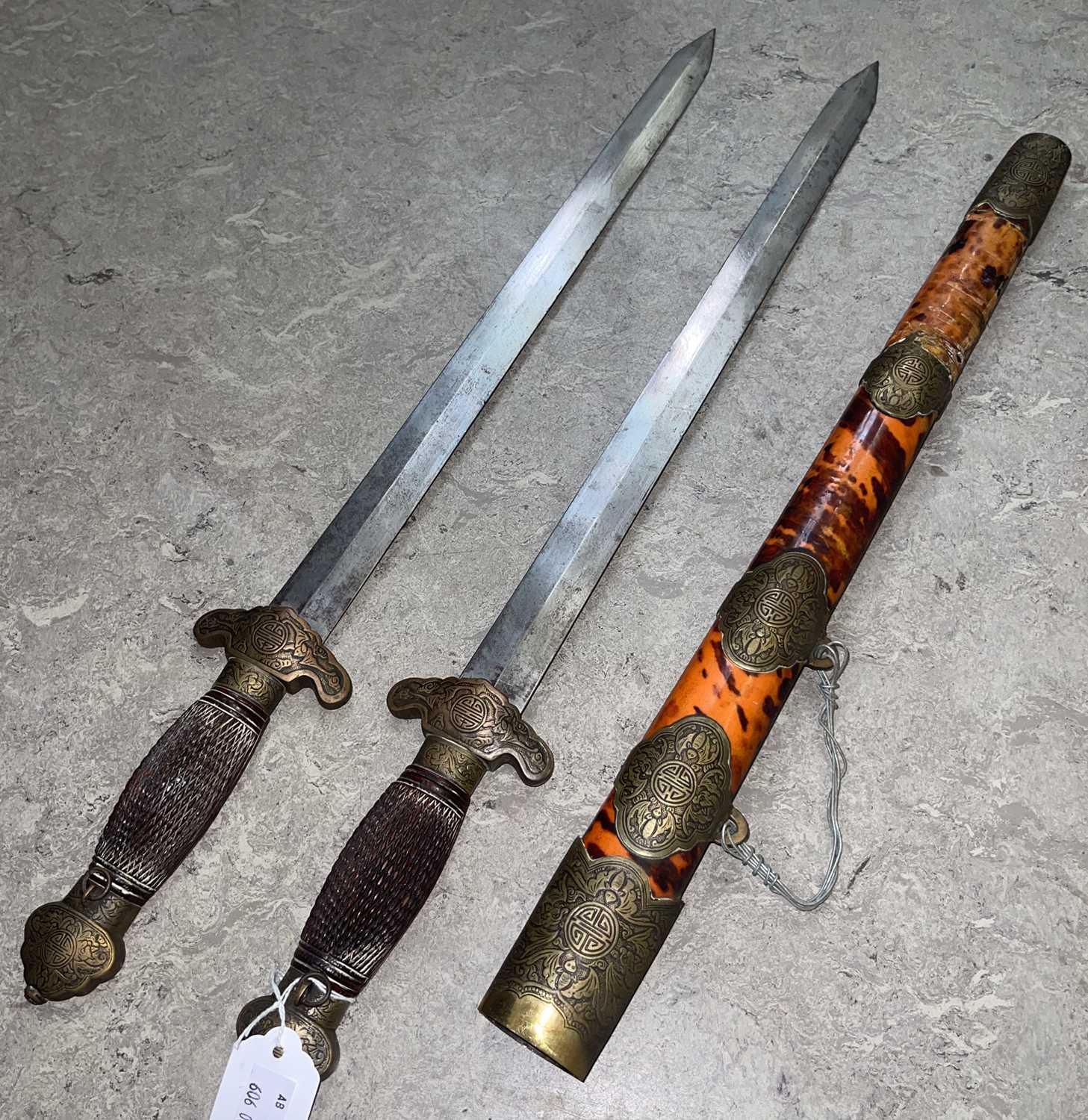 Lot 553 - A Chinese brass mounted double short sword