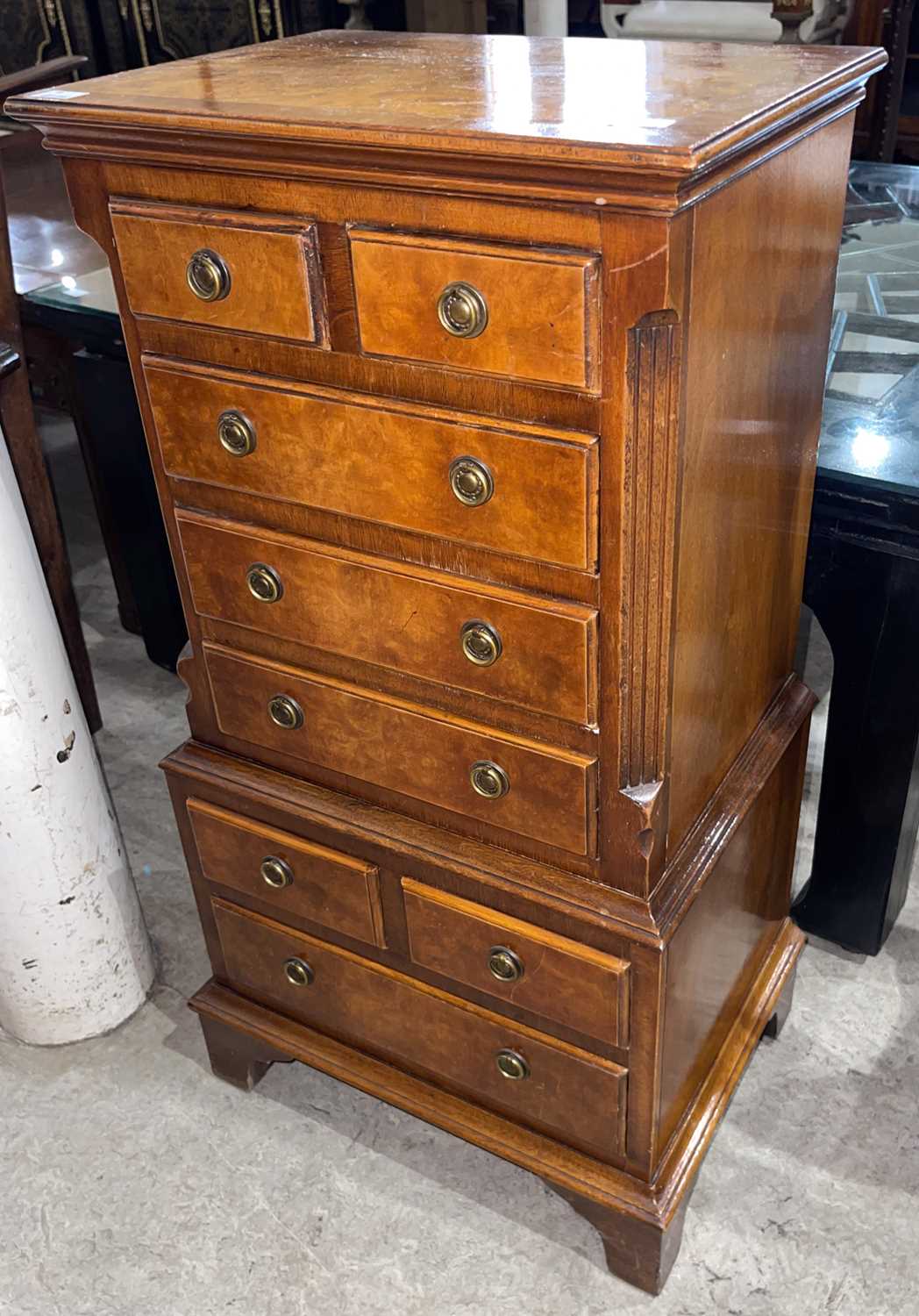 Lot 725 - A reproduction walnut miniature chest on