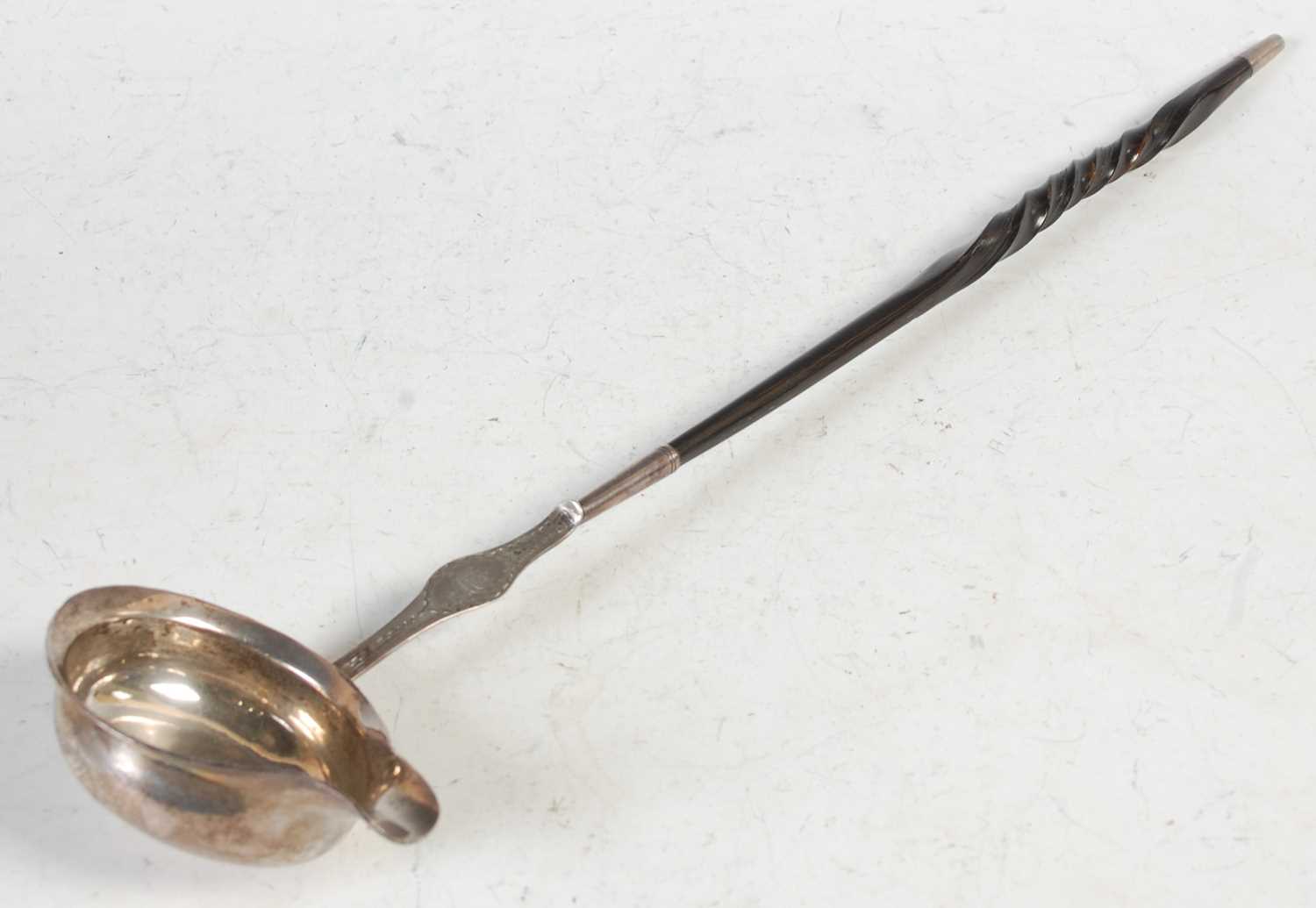 Lot 219 - An antique white metal toddy ladle with