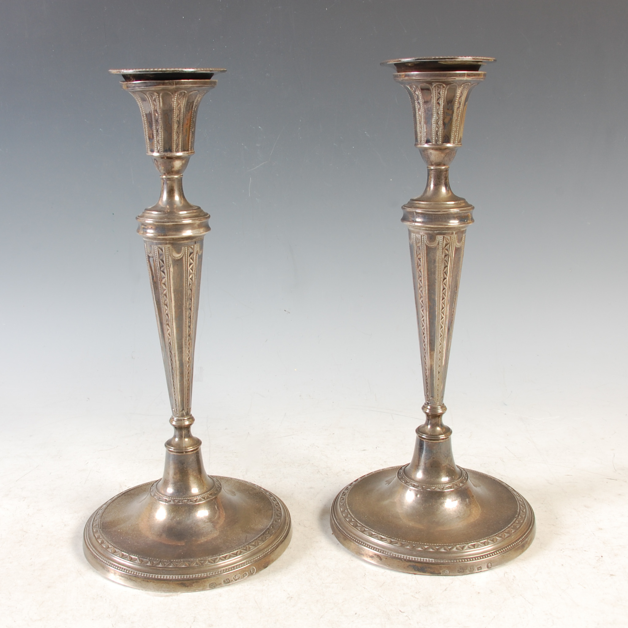 Lot 70 - A pair of George III silver candlesticks,