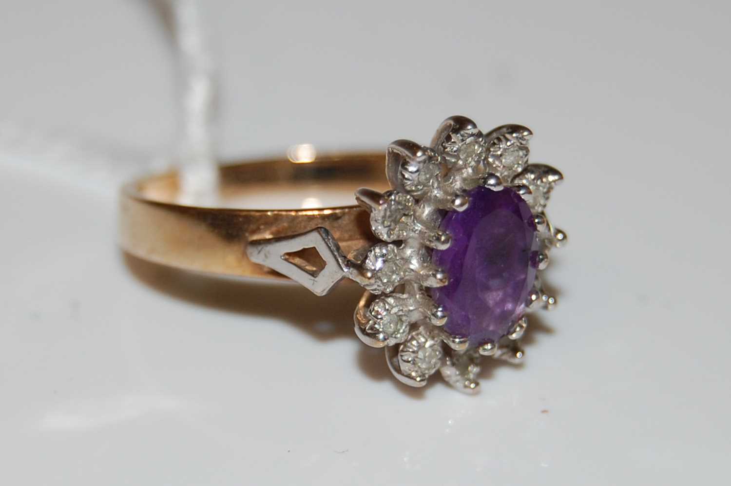 Lot 43 - A 9ct gold, amethyst and diamond chip flower
