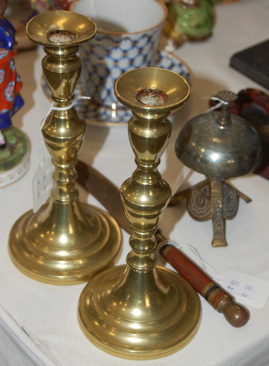 Lot 373 - Two brass candlesticks, a mixed metal table
