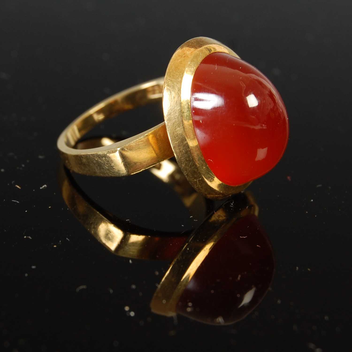 Lot 508 - Bucherer, a yellow metal carnelian cabochon
