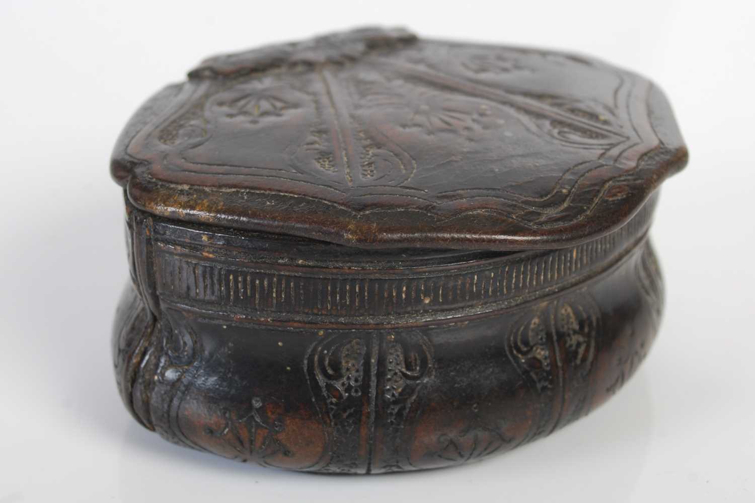 Lot 268 - A pressed leather cartouche-shaped snuff box,