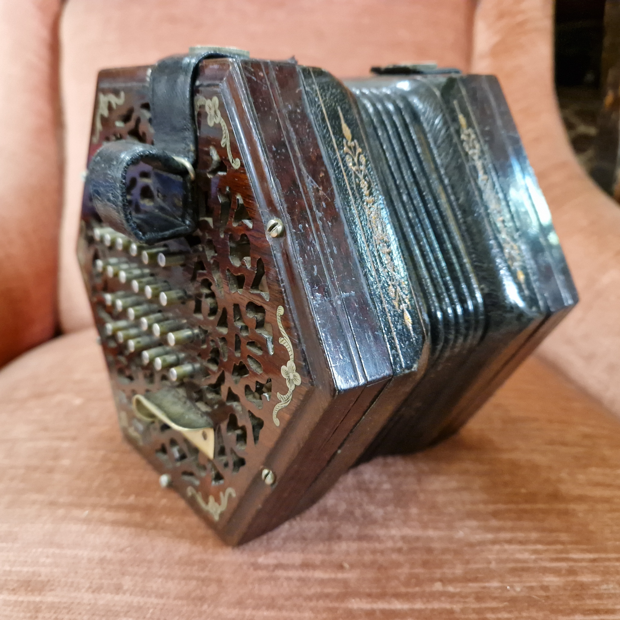 Lot 454 - An antique squeeze box with fret-cut ends