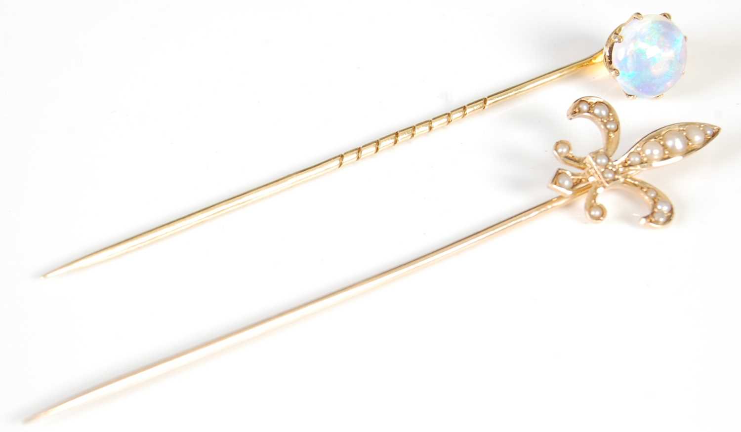 Lot 451 - Two early 20th century yellow metal stick