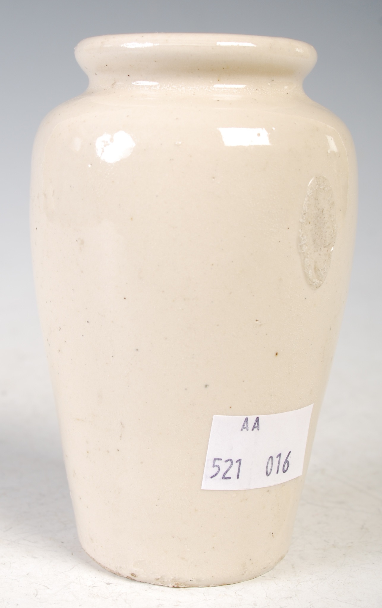 Lot 31 - A 19th century stoneware cream pot with black