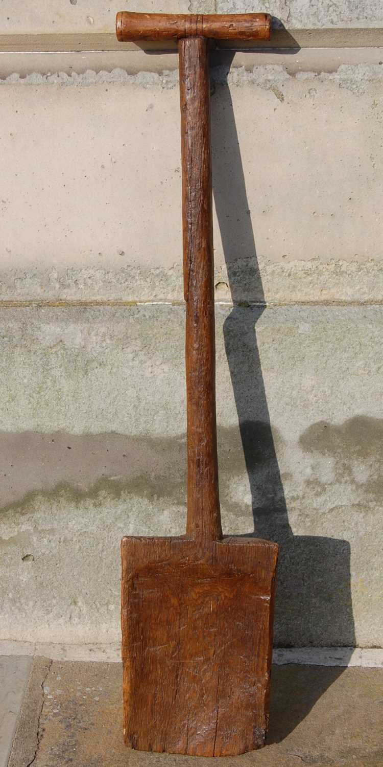 Lot 129 - An antique wooden peat spade, 109cm long