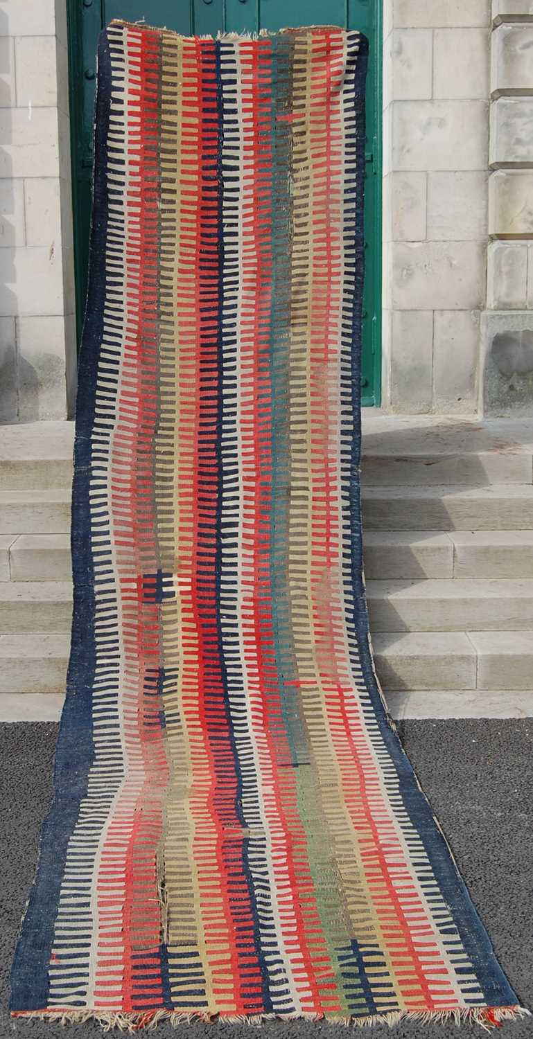Lot 120 - A blue ground kelim runner, decorated with