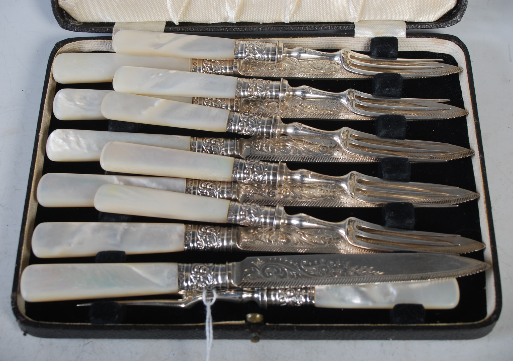 Lot 189 - A set of six mother-of-pearl handled, silver