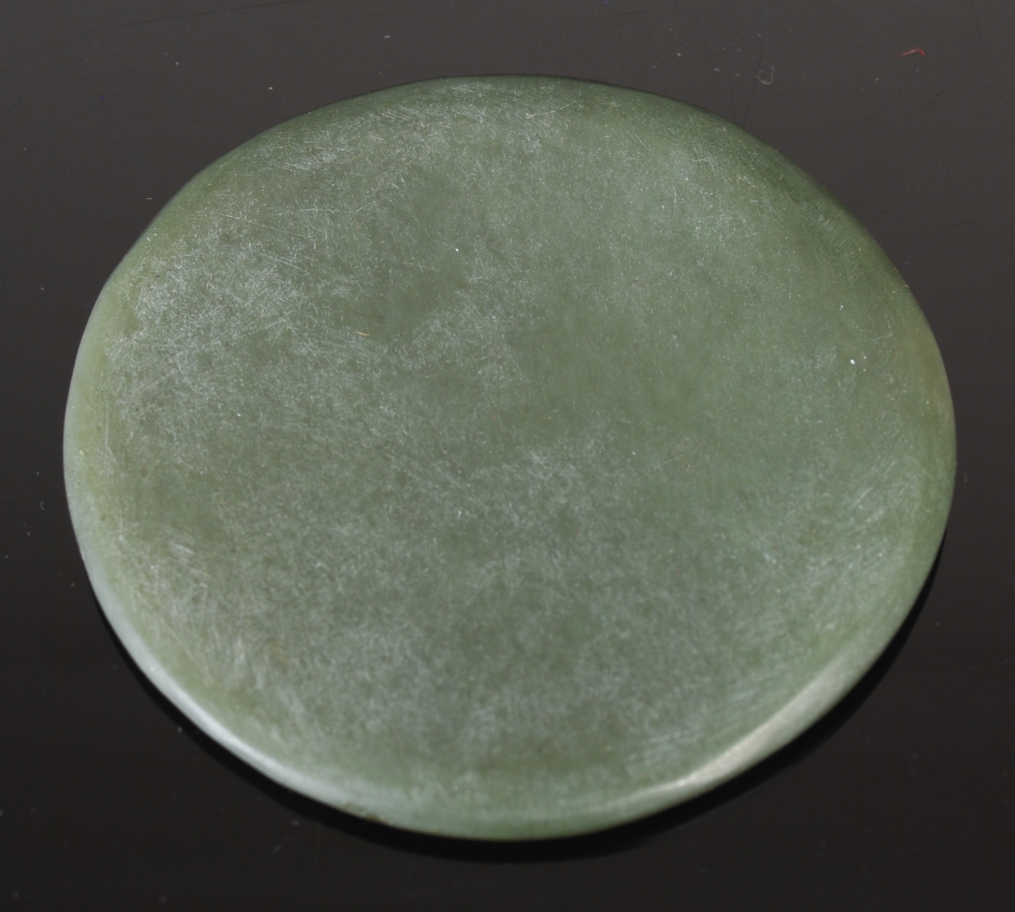 Lot 587 - A Chinese pale celadon jade panel, carved