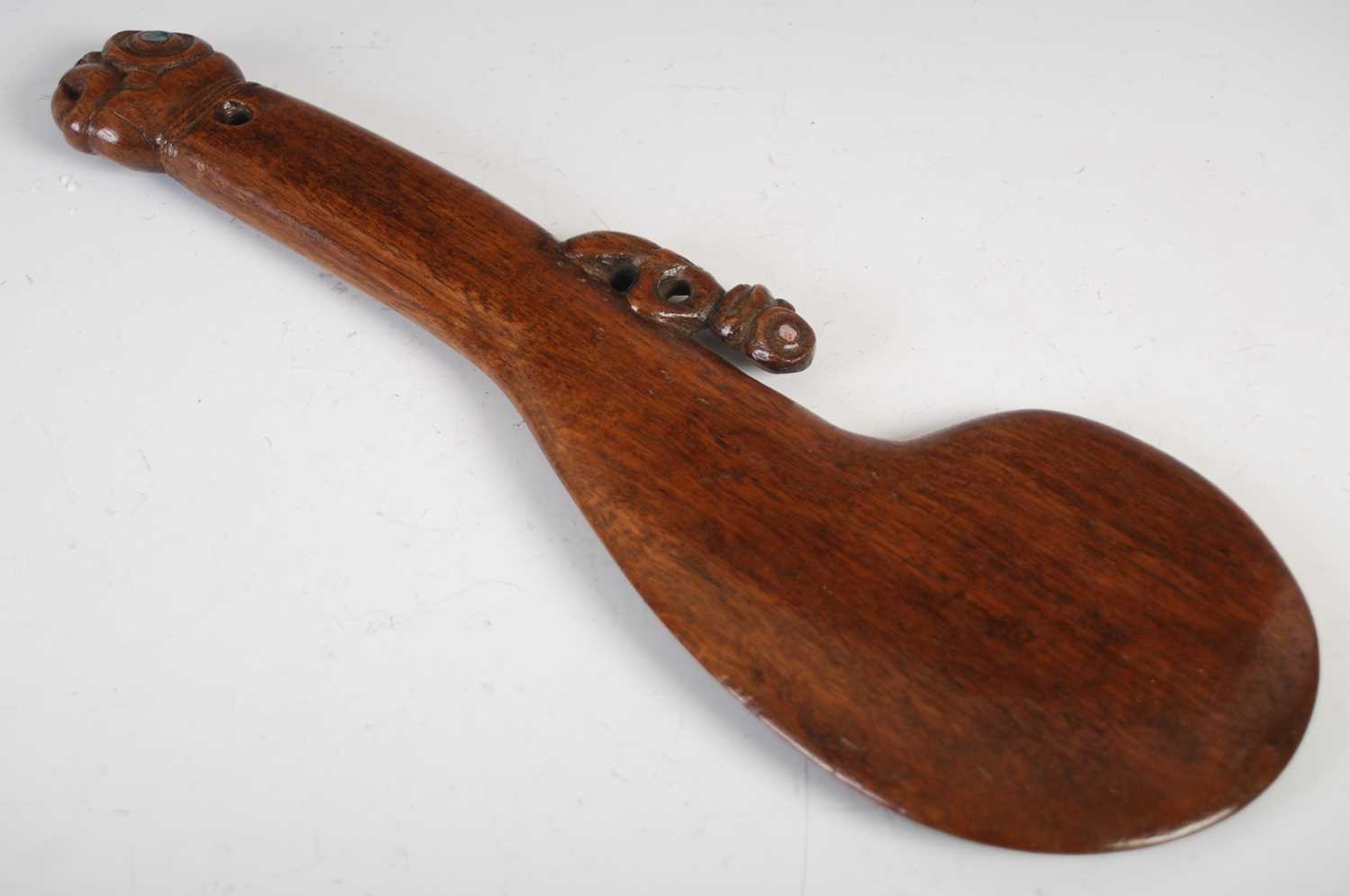 Lot 143 - A Māori wood Patu, carved with stylised