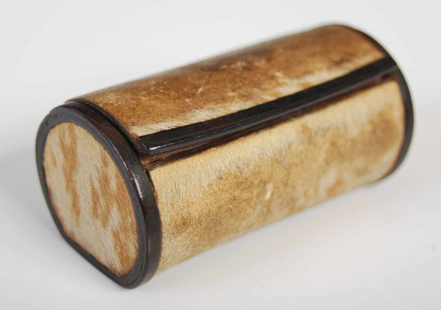 Lot 192 - A small leather cylindrical snuff box in the