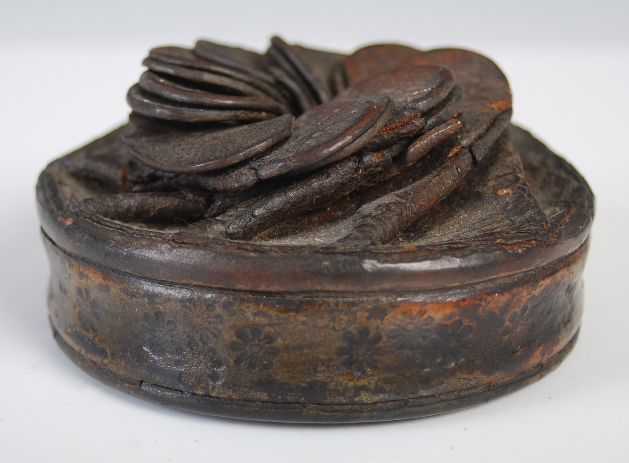 Lot 205 - A leather circular snuff box with folded
