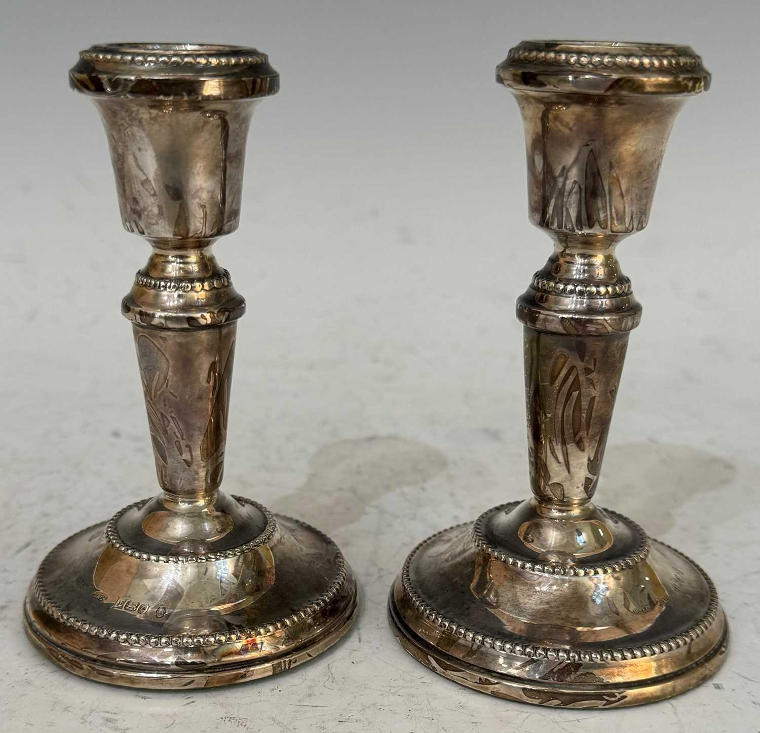 Lot 128 - A pair of Birmingham silver candlesticks,