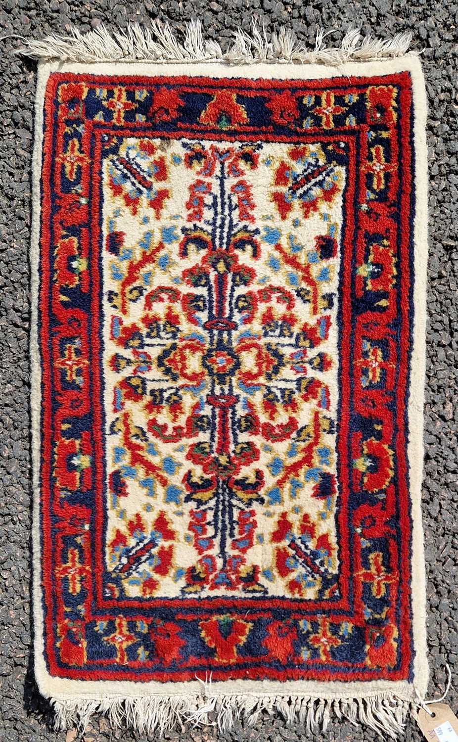 Lot 991 - A small Persian mat, the ivory ground