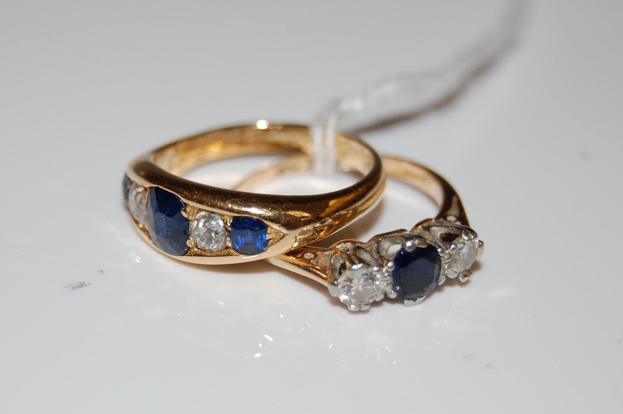Lot 66 - Two rings to include a yellow metal, sapphire